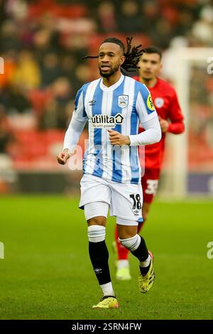 David Kasumu #18 of Huddersfield Town competes for the ball with Ben ...