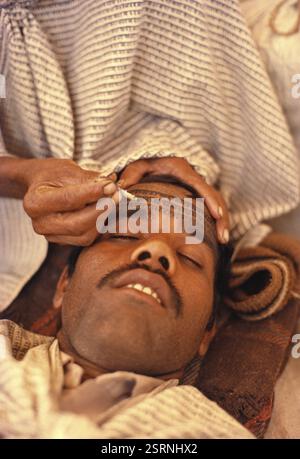 Ramnaami devotee begins by tattooing his forehead with the repetitive ...