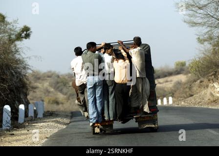 Passengers travelling on footstep of jeep, Rajasthan, India, Asia Stock ...