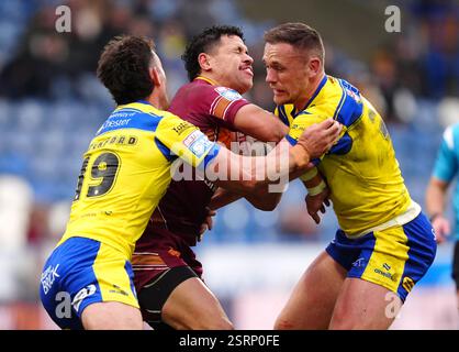 Huddersfield Giants' Jacob Gagai (centre) tackled by Leigh Leopards ...