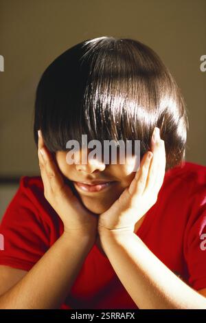 Girl kept both hands on both cheeks MR#152 Stock Photo - Alamy