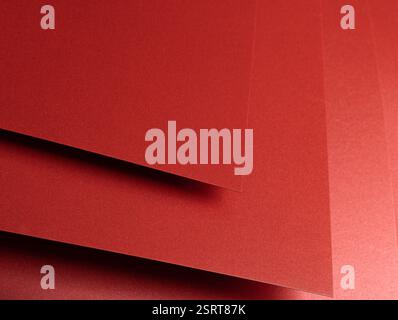 Deep garnet red paper background with a glossy, reflective texture and ...