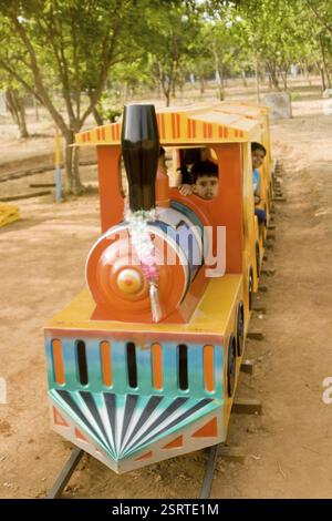 Children in orange color toy train Stock Photo - Alamy