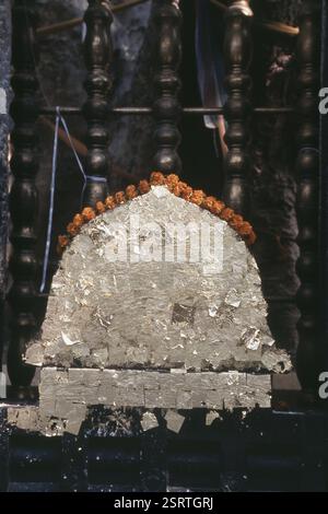 Holy stone with thin gold plates in front of Bodhi tree, Mahabodhi ...