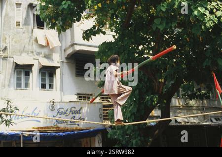 Street performer balancing on rope Stock Photo - Alamy