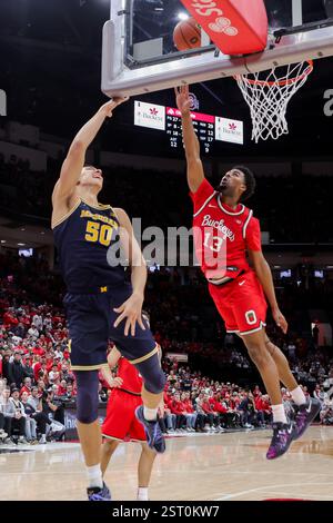 Michigan center Vladislav Goldin (50) lays in a shot against Michigan ...