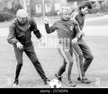West German national soccer team forward Gerd Mueller, center, embraces ...