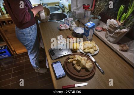 Baking an apple pie with mobile phone instructions, Bavaria, Germany ...