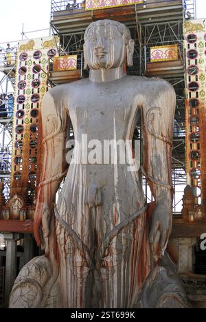 Jain Devotees pouring Vermillion Water on the head of 58.8 feet monolithic Statue of jain saint ...