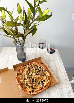 Homemade pizza with olives, peppers and two variety of cheeses Stock ...