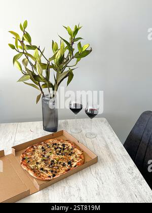 Homemade pizza with olives, peppers and two variety of cheeses Stock ...