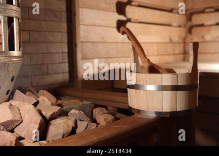 Bucket, ladle and stove with hot rocks in sauna Stock Photo - Alamy
