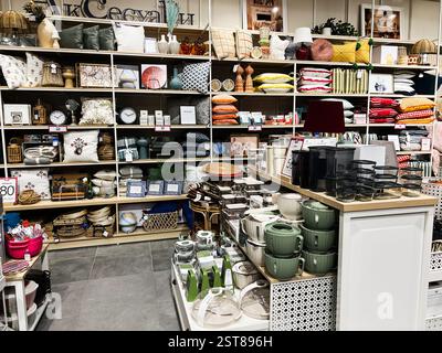 Modern counters and shelves with kitchenware in light room interior ...