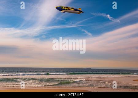 Goodyear Blimp flies over the ocean in Hermosa Beach showing coastline ...