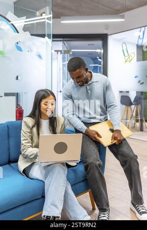 Two men discuss the growth of the company, looking at the rising graph ...