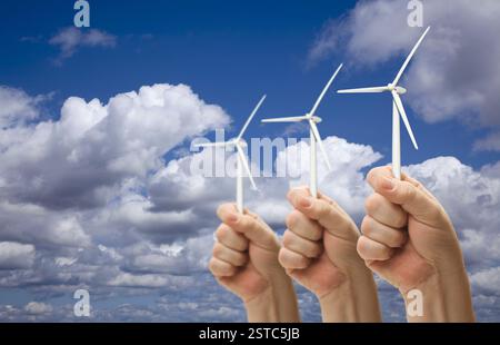 Male Fists Holding Three Wind Turbines Outside Stock Photo - Alamy