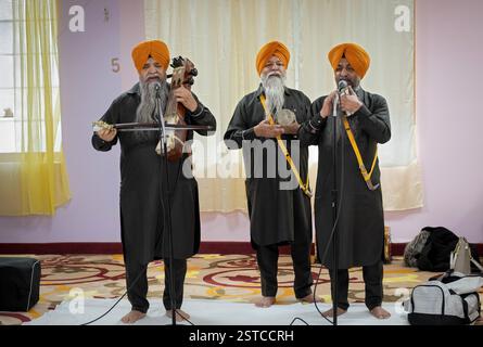 Musicians & priests perform kirtan devotional singing & chanting. In A ...