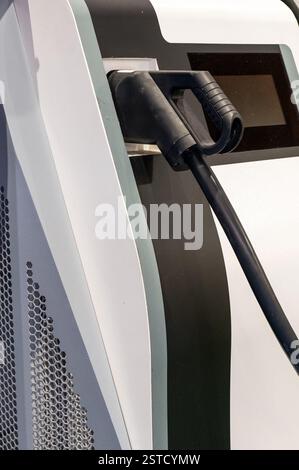 Closeup EV charging connector and electric car. Sustainable driving ...