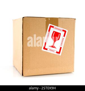 Fragile filled carton box isolated on white Stock Photo - Alamy
