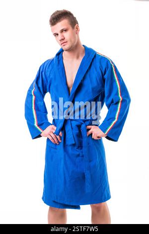 Young man wearing blue bathrobe, relaxed lifestyle over isolated ...
