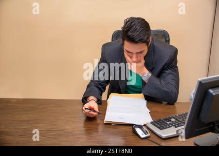 Preoccupied, worried, desperate young male worker staring at computer ...
