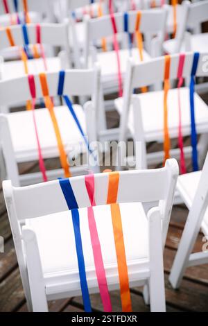 white chairs decorated with pink ribbons for wedding ceremony closeup ...