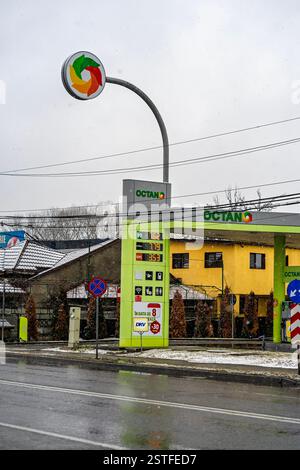 Exterior of an OCTANO gas station. Gasoline pumps and cars refueling in ...