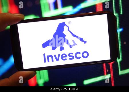 In this photo illustration, the Invesco logo is seen on a smartphone ...