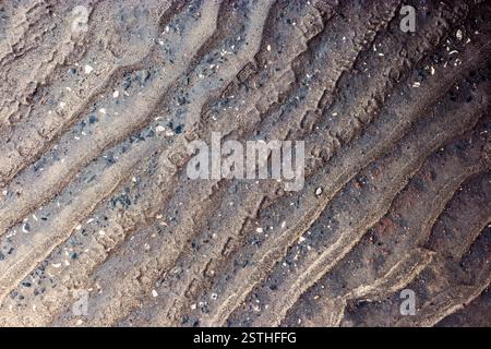 Waves pattern of sand on asphalt road after rain, dirty road texture ...