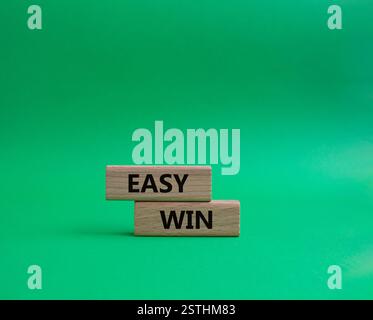 Easy win symbol. Wooden blocks with words Easy win. Beautiful yellow ...
