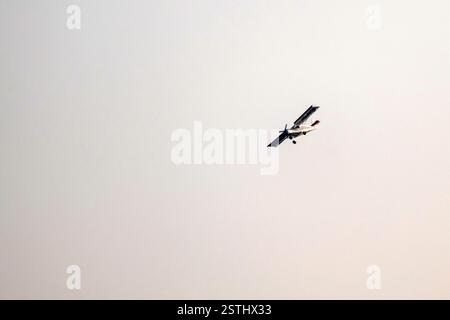 Classical Propeller airplane plane is flying on isolated blue sky in ...