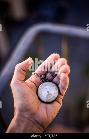 Hands holding antique clock and gears Stock Photo - Alamy