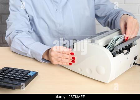 Cashier with money at bank, closeup. Currency exchange Stock Photo - Alamy