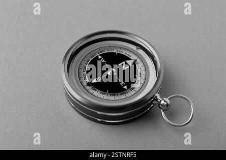 Compass on table, closeup. Toned in black-and-white Stock Photo - Alamy