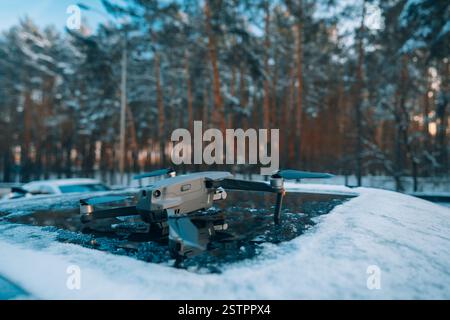 quadrocopter standing on the roof of a snow-covered car Stock Photo - Alamy