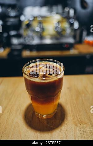 Layered alcoholic cocktails, on a wooden board on a black background ...