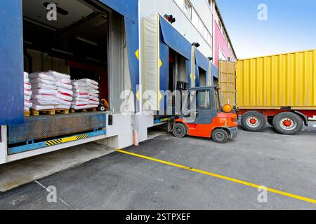 Forklift at cargo dock of big warehouse Stock Photo - Alamy