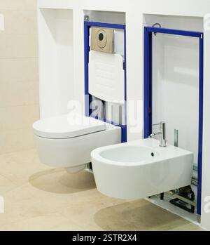 Construction work fitting toilet and water reservoir Stock Photo - Alamy