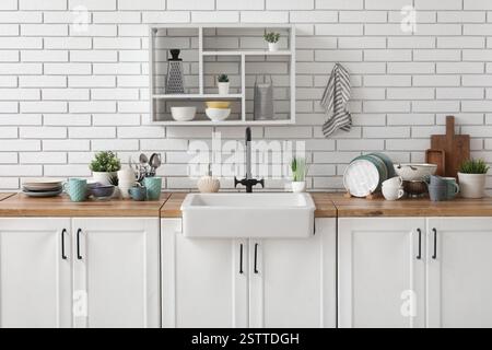 Shelving unit with wooden table and hanging lamp in modern room Stock ...