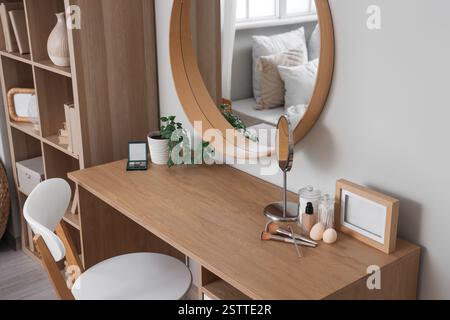 Dressing table with mirror, cosmetic products and perfumes near white ...