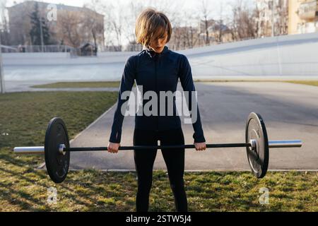 Strong woman exercising with barbell. Sports, fitness concept Stock ...