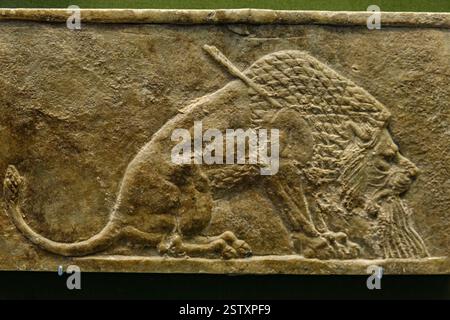 a wounded lion vomiting blood from its mouth, part of the sculptural ...