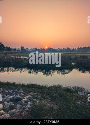 Majestic sunrise over Asan Barrage, Dehradun, with orange sky and vast ...