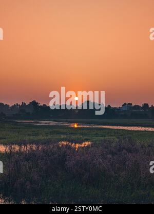 Majestic sunrise over Asan Barrage, Dehradun, with orange sky and vast ...