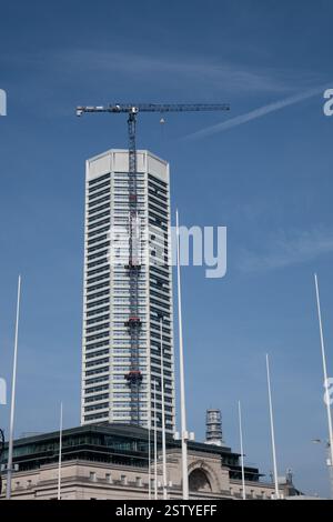 Modern high-rise building under construction with glass windows and ...