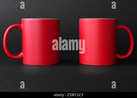 Two blank red mugs on white background, top view. Mockup for design ...