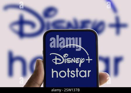 The Disney Plus logo is displayed on a mobile phone with the company ...