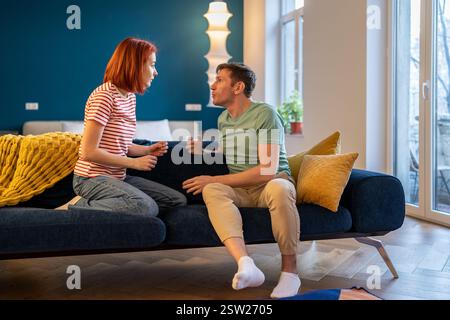 Angry unhappy millennial european husband and wife arguing at ...