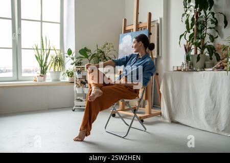 Woman looks thoughtful in window. Peace and mindfulness Stock Photo - Alamy