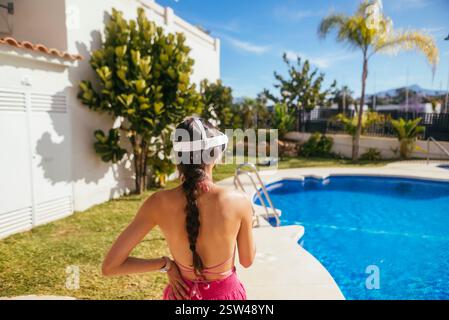 Young beautiful woman wearing a VR headset and experiencing a virtual ...